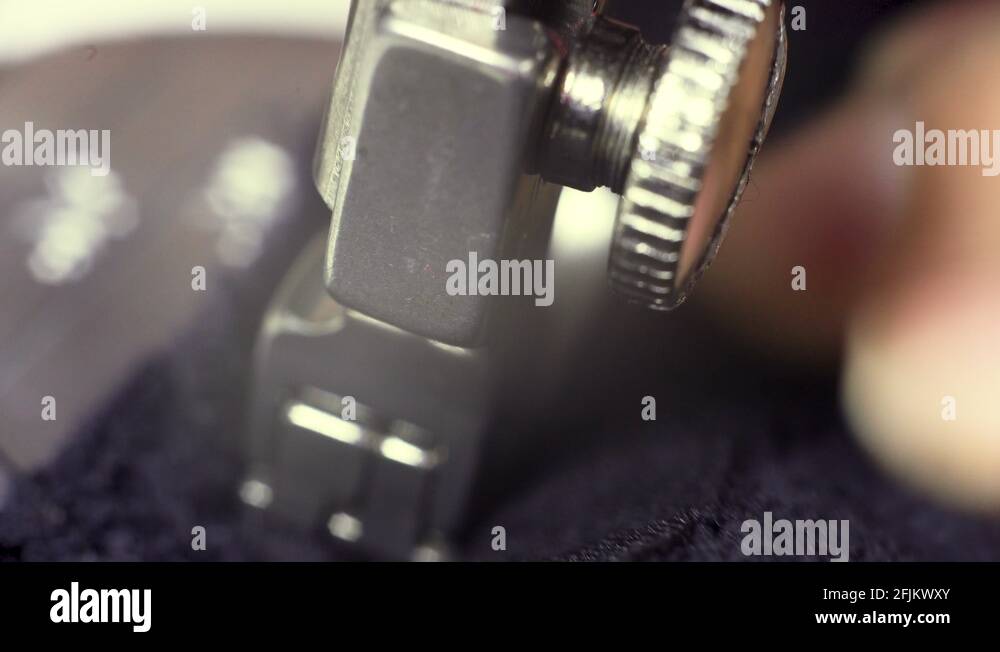 Macro up close seamstress using sewing machine needle stabbing two ...