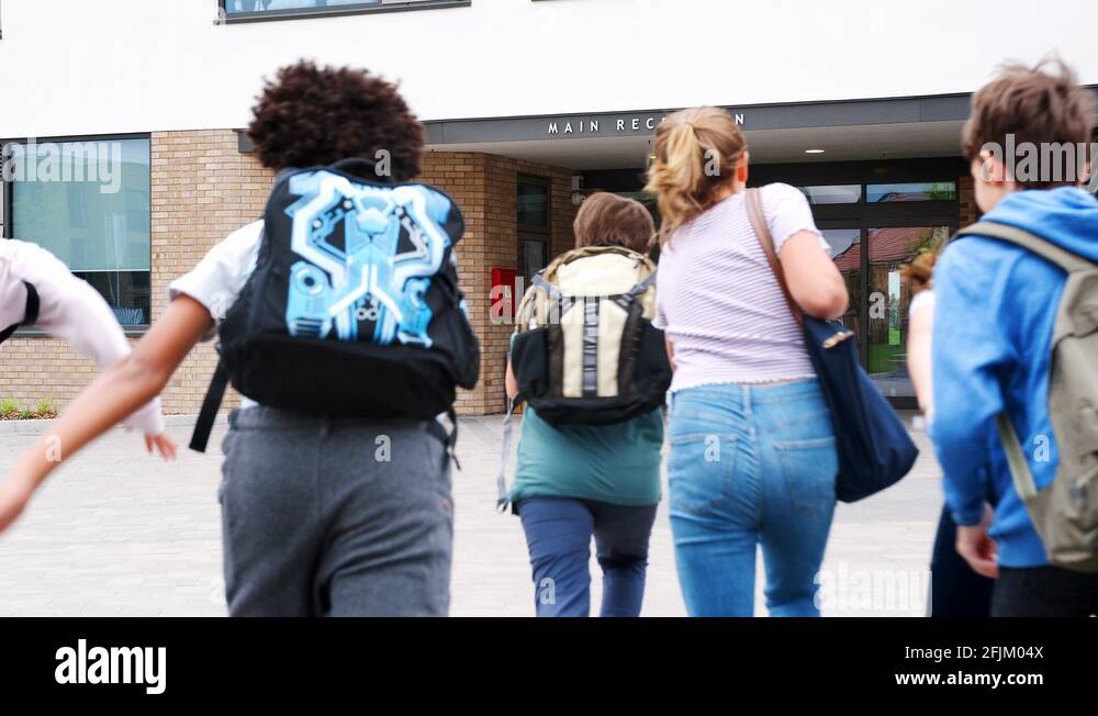 Group Of High School Students Running Into School Building At Beginning ...