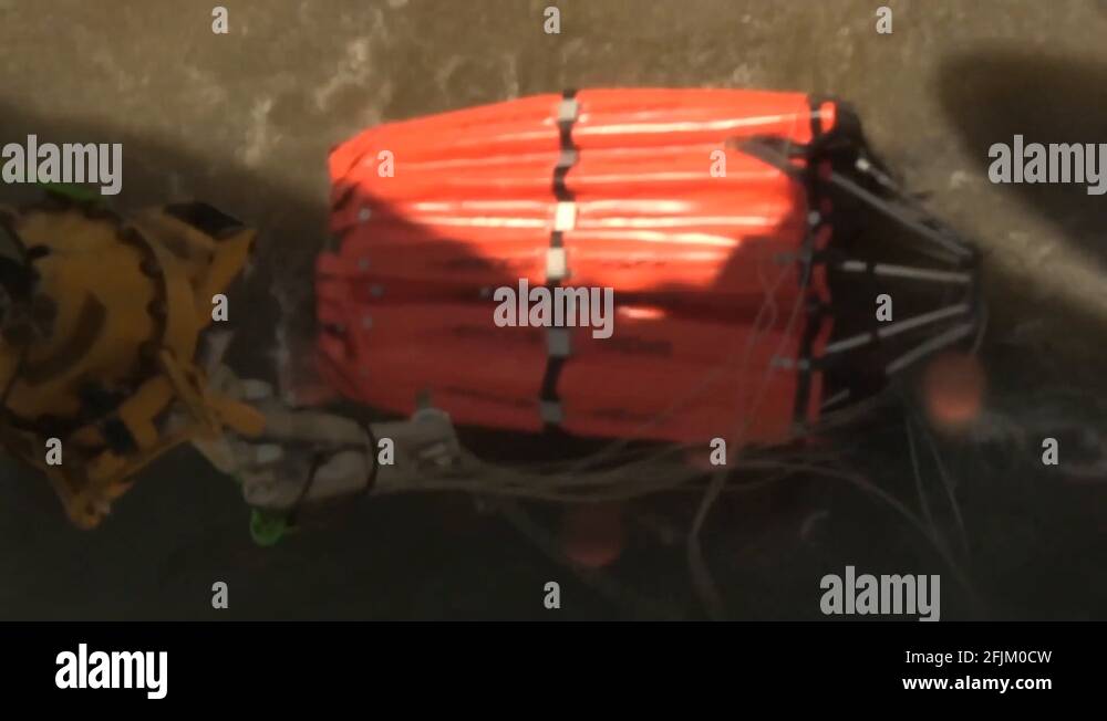 Water being sprinkled from Bambi bucket in mid-air fire fighting ...