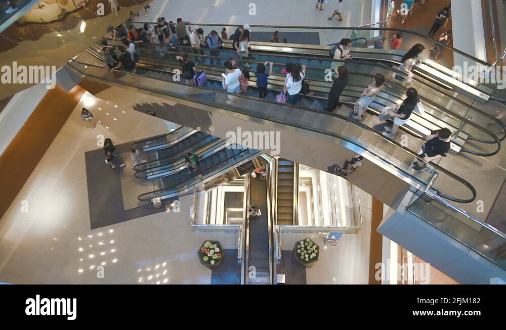 Escalators in modern shopping mall. Very busy full of clients mall ...