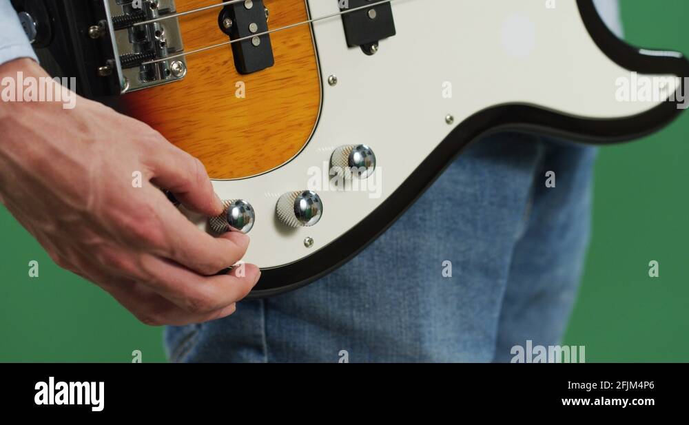 Adjusting the volume controls of an electric guitar Stock Video Footage ...