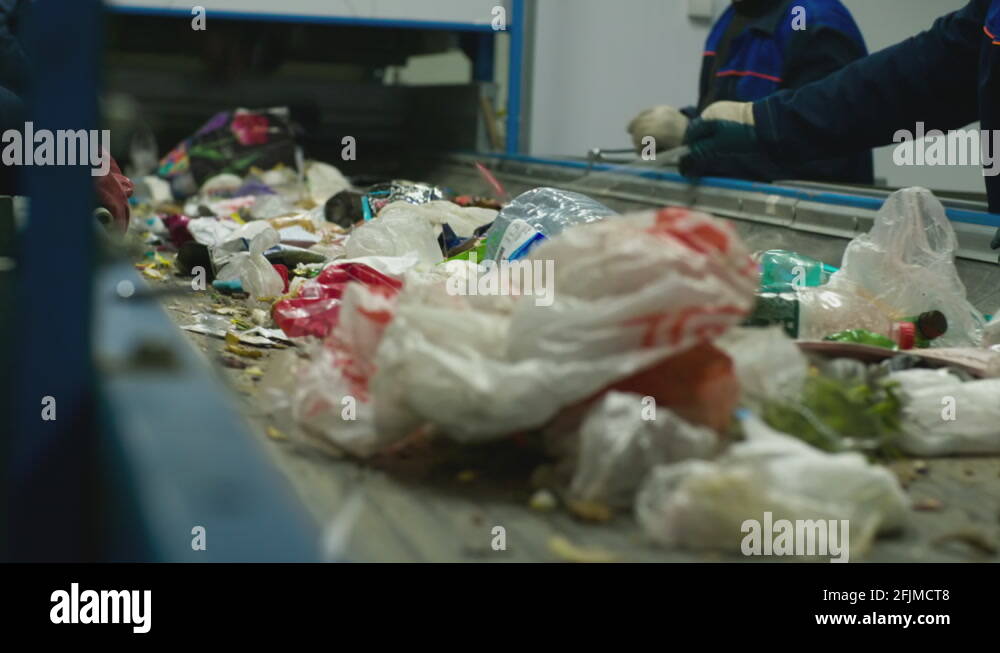 Workers at conveyor sorting garbage at a recycling plant Stock Video Footage - Alamy