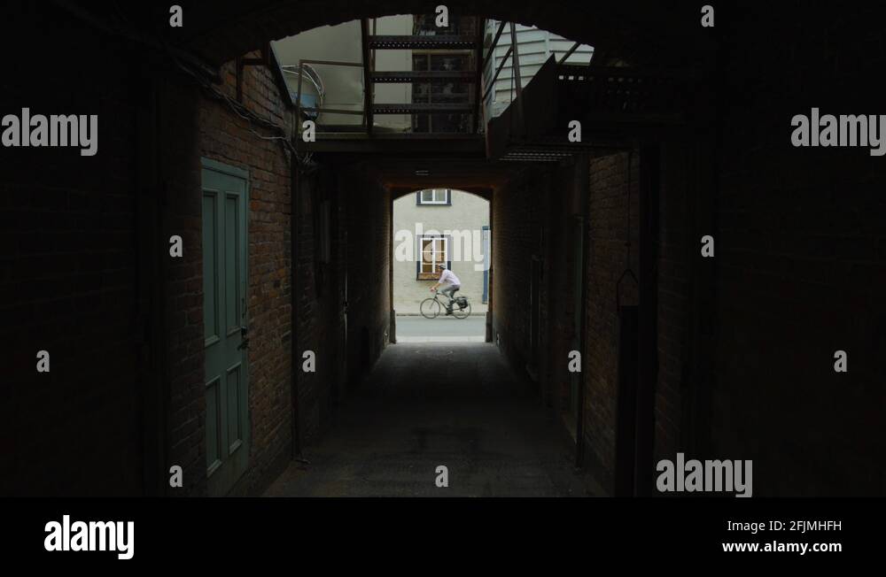 Passage between two brick buildings Stock Video Footage - Alamy