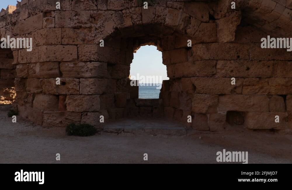 A gimbal dolly-inement shot during sunrise at a window on a brick wall ...
