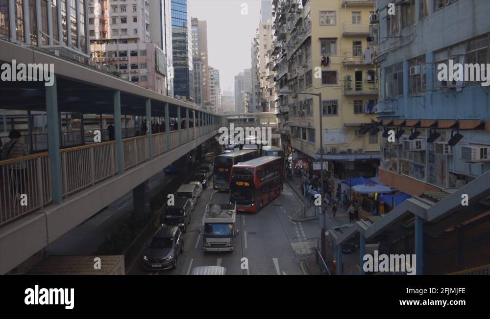 Buses in Hong Kong going under the overpass pedestrian bridge Stock ...