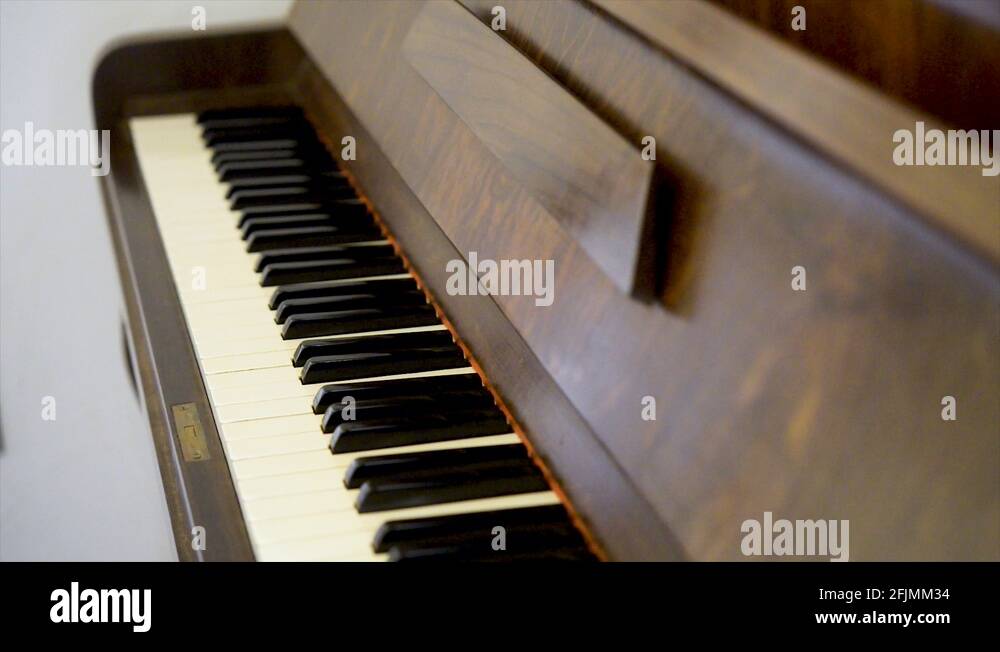Side view of an upright piano keyboard. Moving camera Stock Video ...