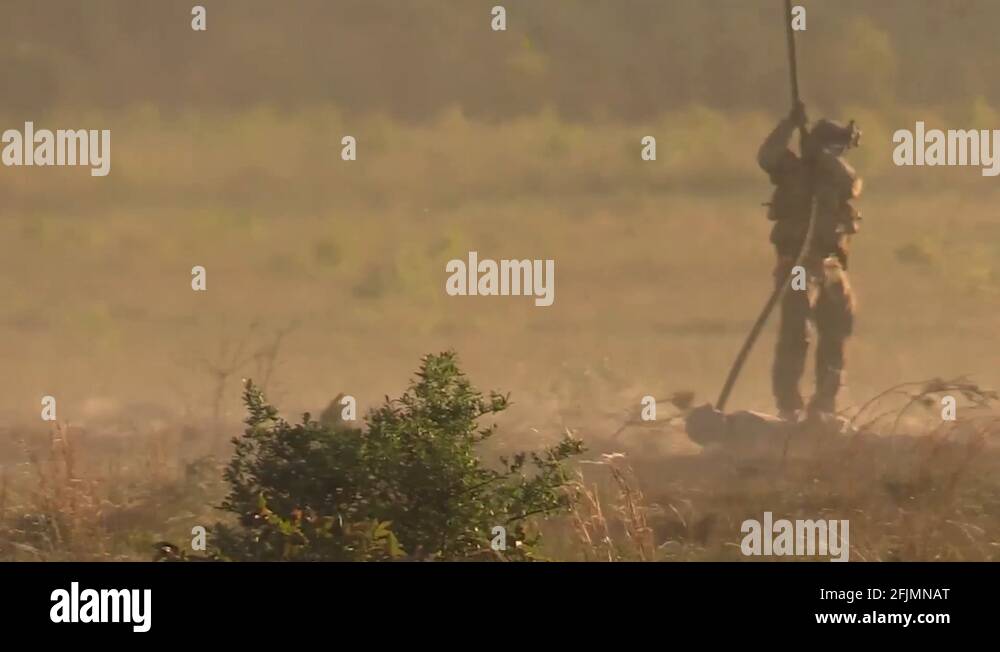 NATO special operations members conduct fast rope training out of a CV ...