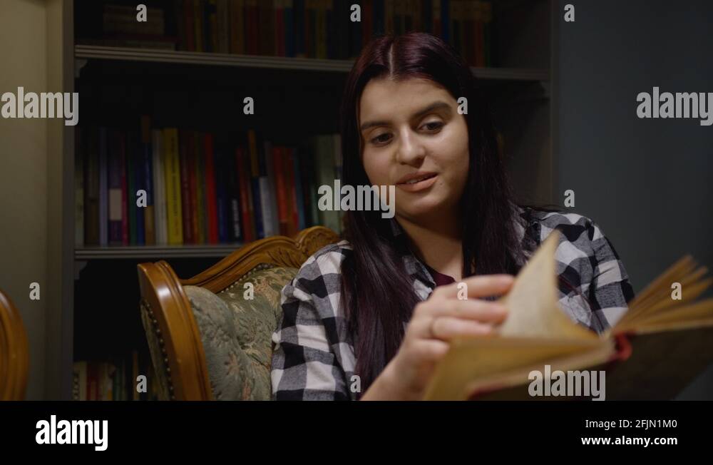 Girl reading a book and talking Stock Video Footage - Alamy