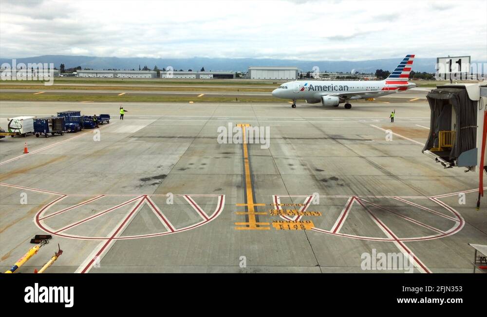 American Airlines plane taxis to gate and stops with aircraft ground ...