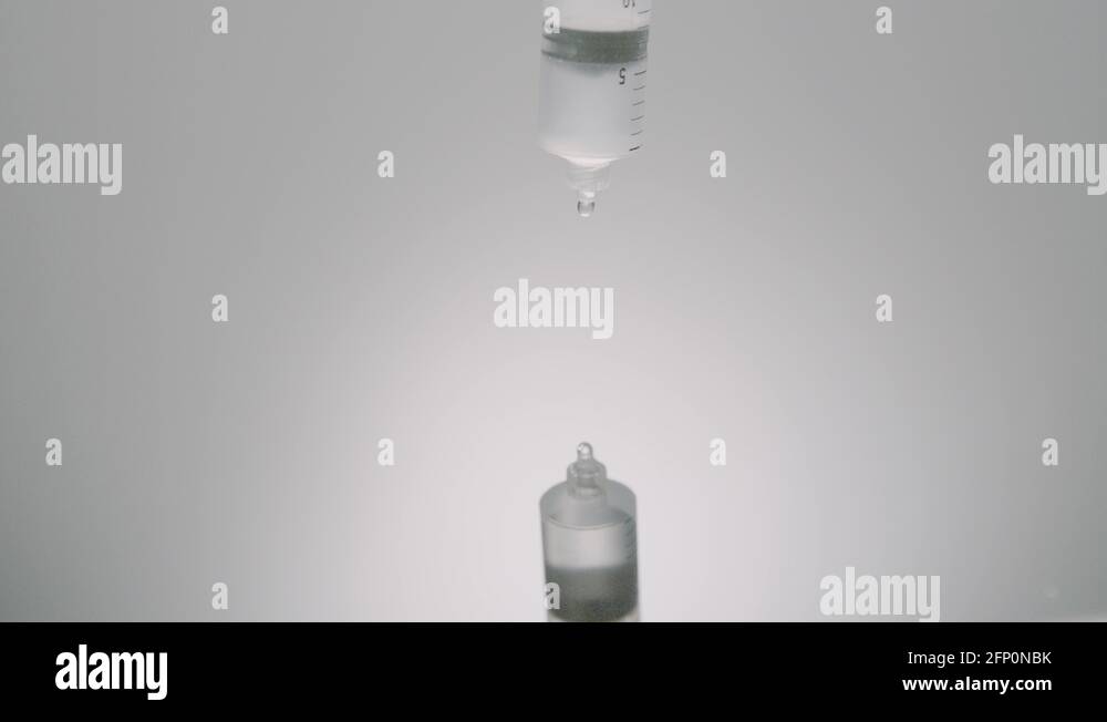 Syringe dripping into liquid Stock Video Footage - Alamy