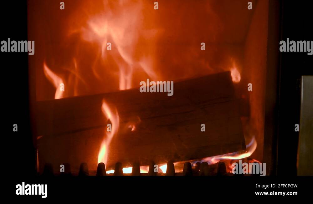 Static shot looking at log inside roaring fire indoor fireplace Stock ...