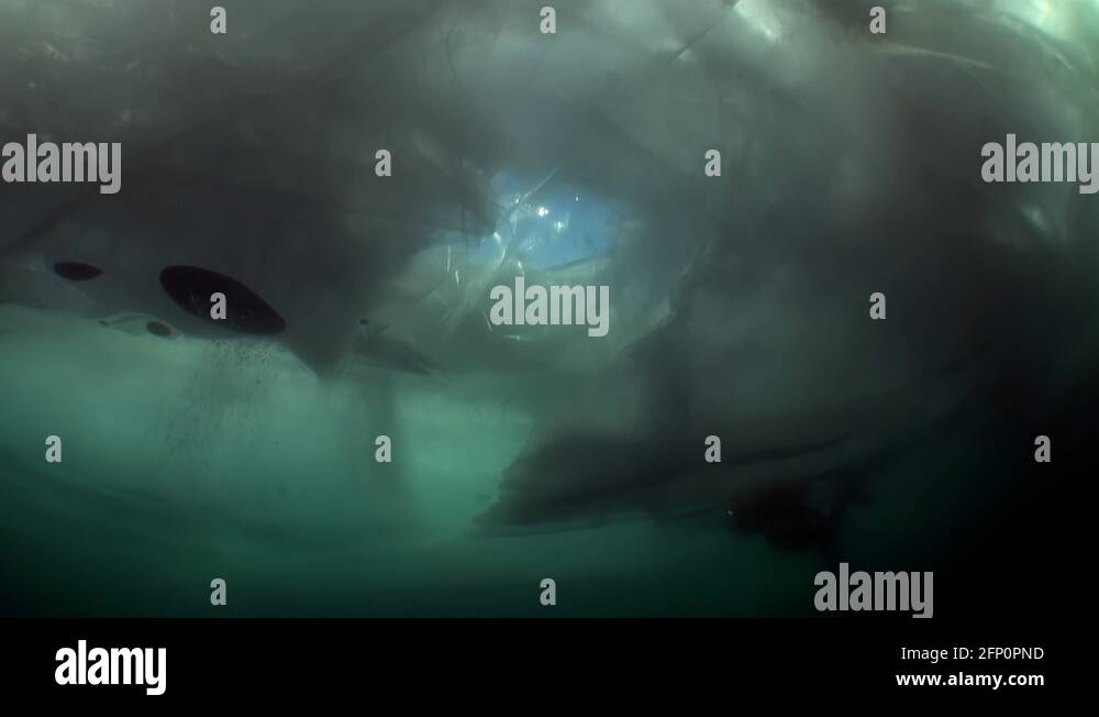 Underwater landscape of clear transparent ice under cold water of lake ...