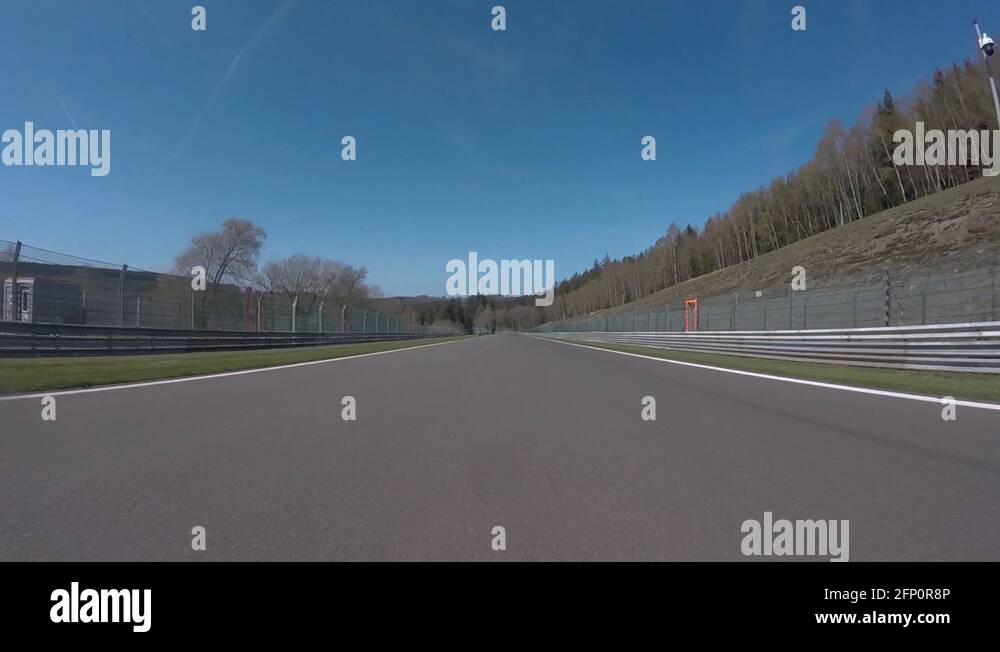 Back point of view of racecars passing by in a Formula 1 race at ...