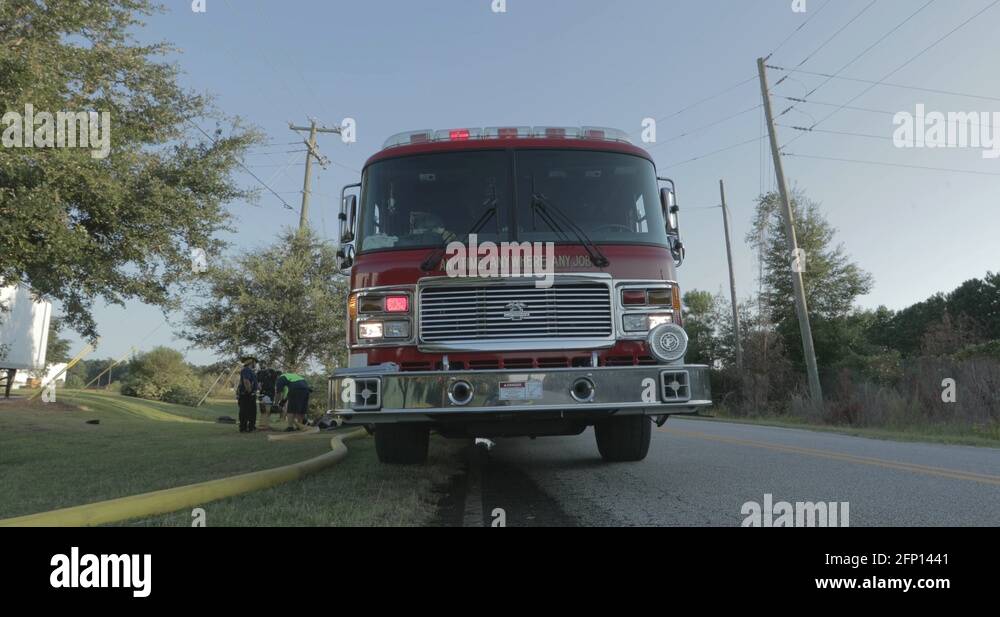 Fire engine with fire hoses attached to a hydrant during emergency ...