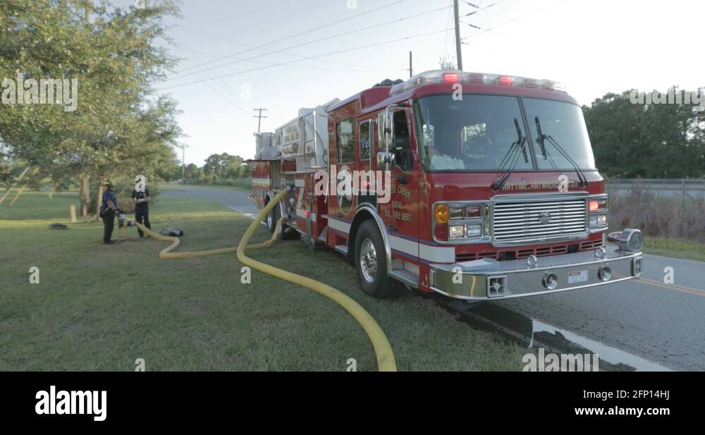 Fire engine with fire hoses attached to a hydrant during emergency ...