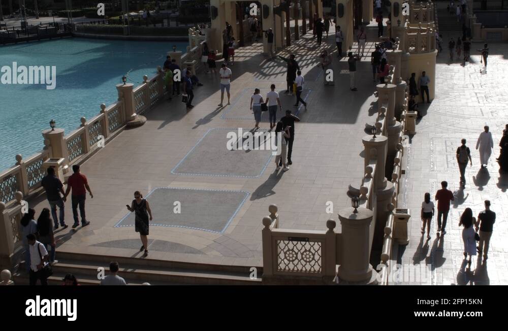 A crowd of people walking at the Dubai mall in the UAE in slow motion ...