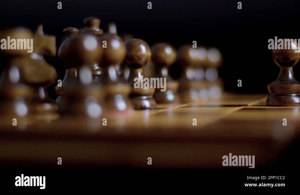 Camera slides right, level with chess set, blurred chess pieces in view ...