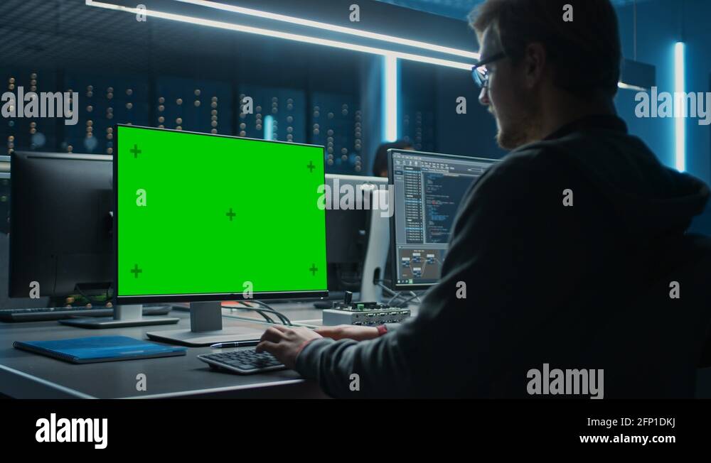 Smart Male IT Programer Working on Desktop Green Mock-up Screen ...