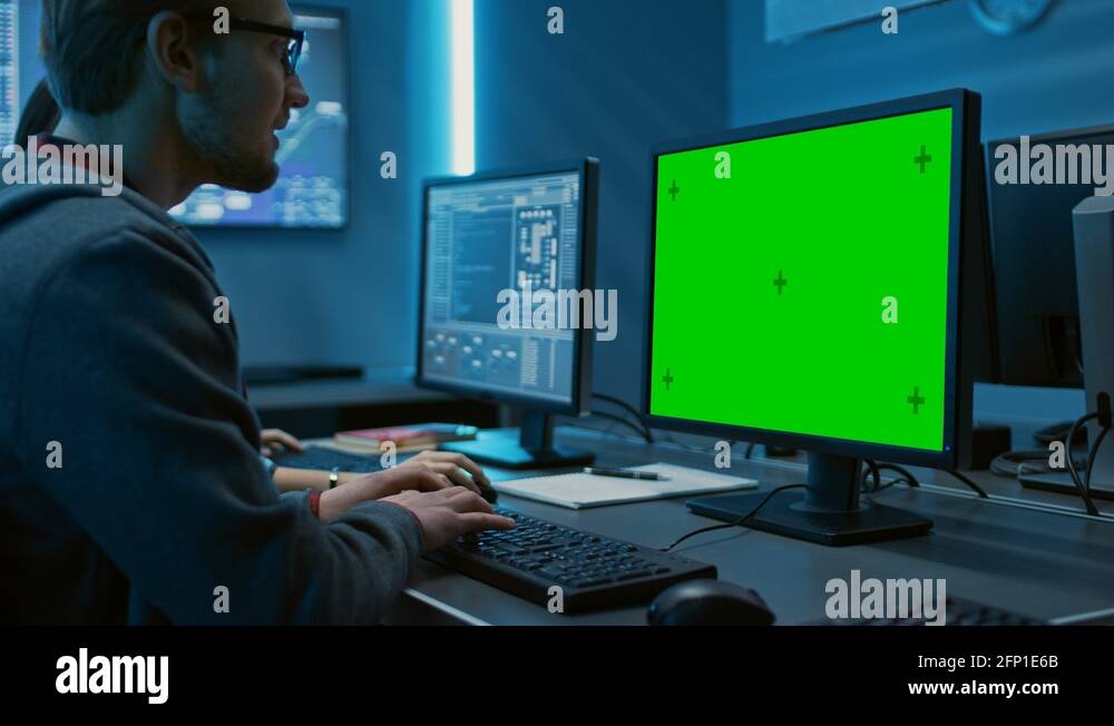IT Programer Working on Desktop Green Mock-up Screen Computer in Data ...