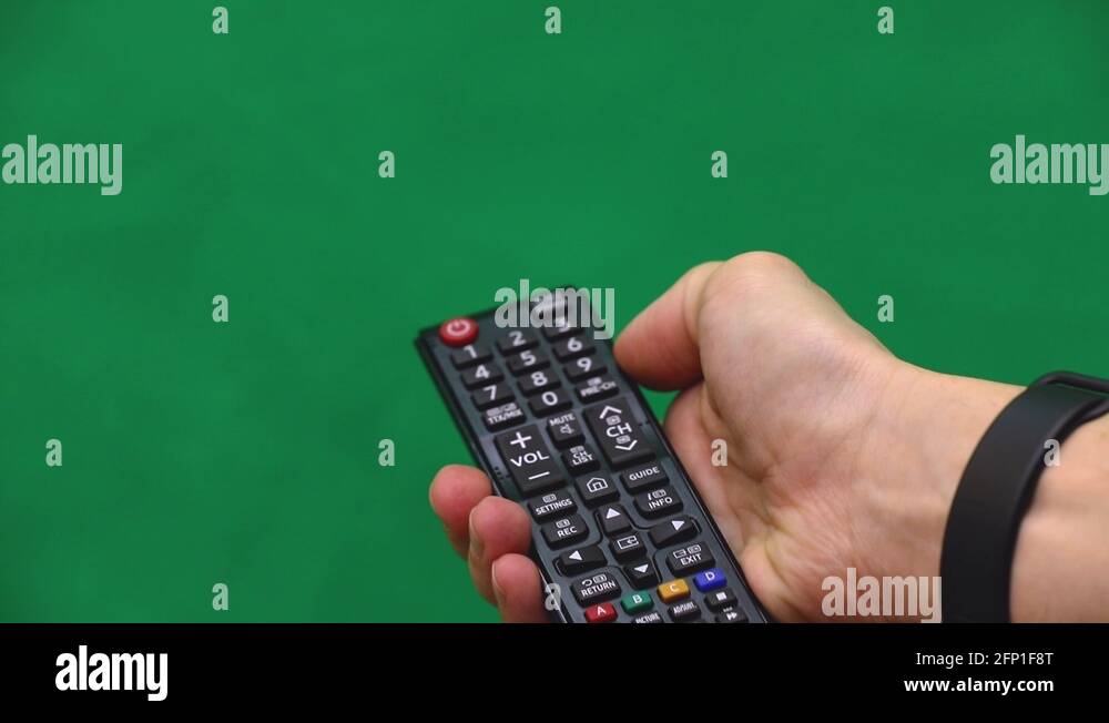 Men's hand. Remote control. Right hand. Green screen. Press the button ...