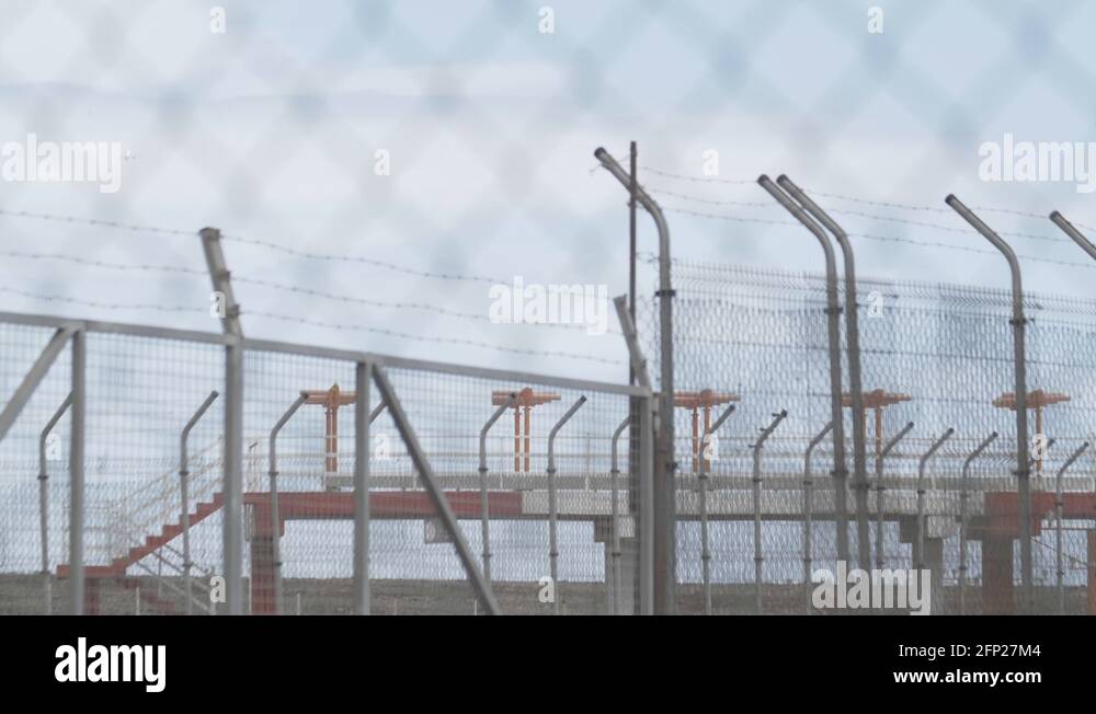 Airbus A320 seen through security fencing landing in slow motion Stock ...