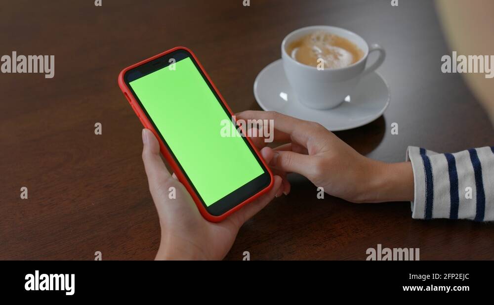 Woman use of mobile phone with green screen Stock Video Footage - Alamy