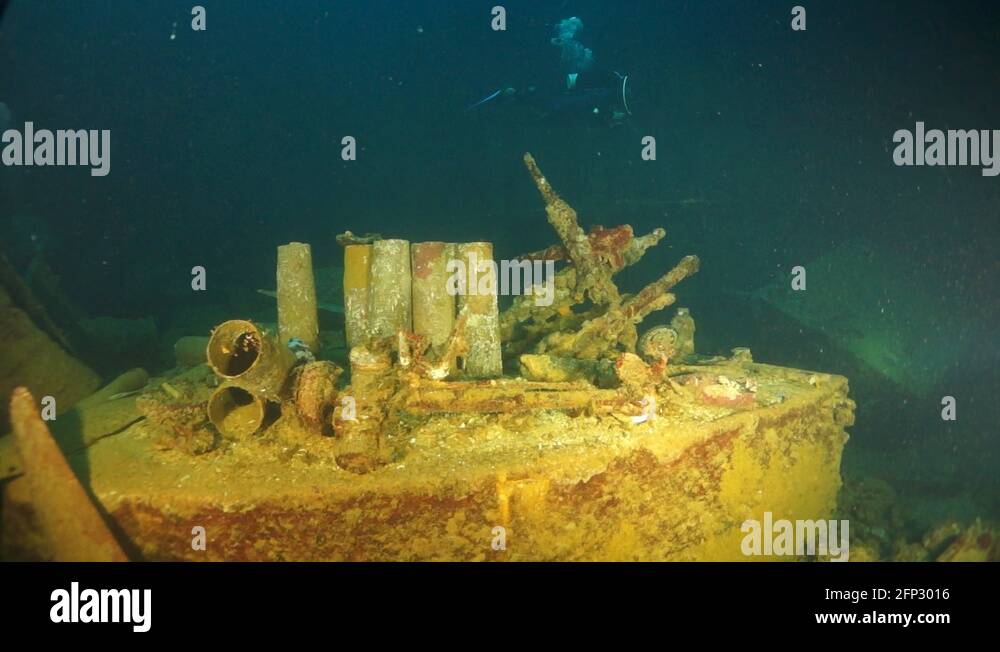 Diver inside hull of sunken ship underwater of Pacific Ocean on Chuuk ...