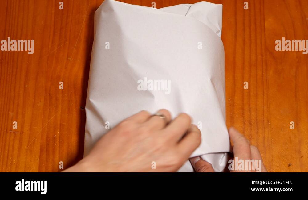 Man opens paper wrapper with fish and chips inside. TOP DOWN ANGLE ...