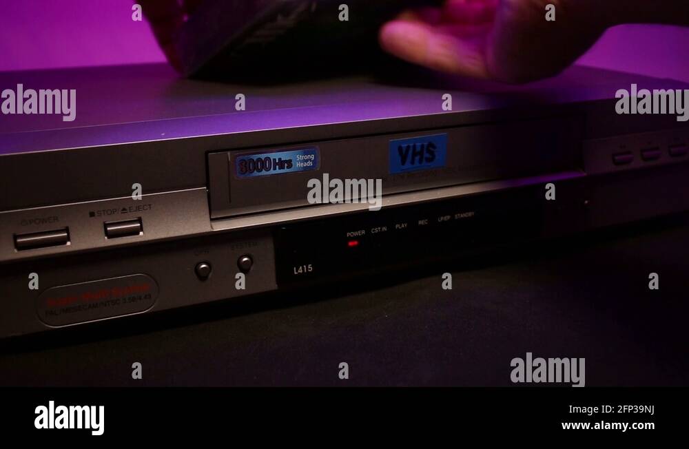 Inserting Anniversary VHS Video Tape Into A VCR Player Stock Video ...