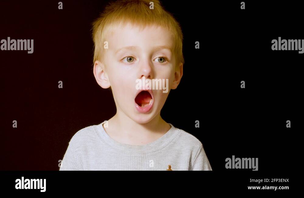 Motion studio portrait of an adorable little blonde boy acting ...