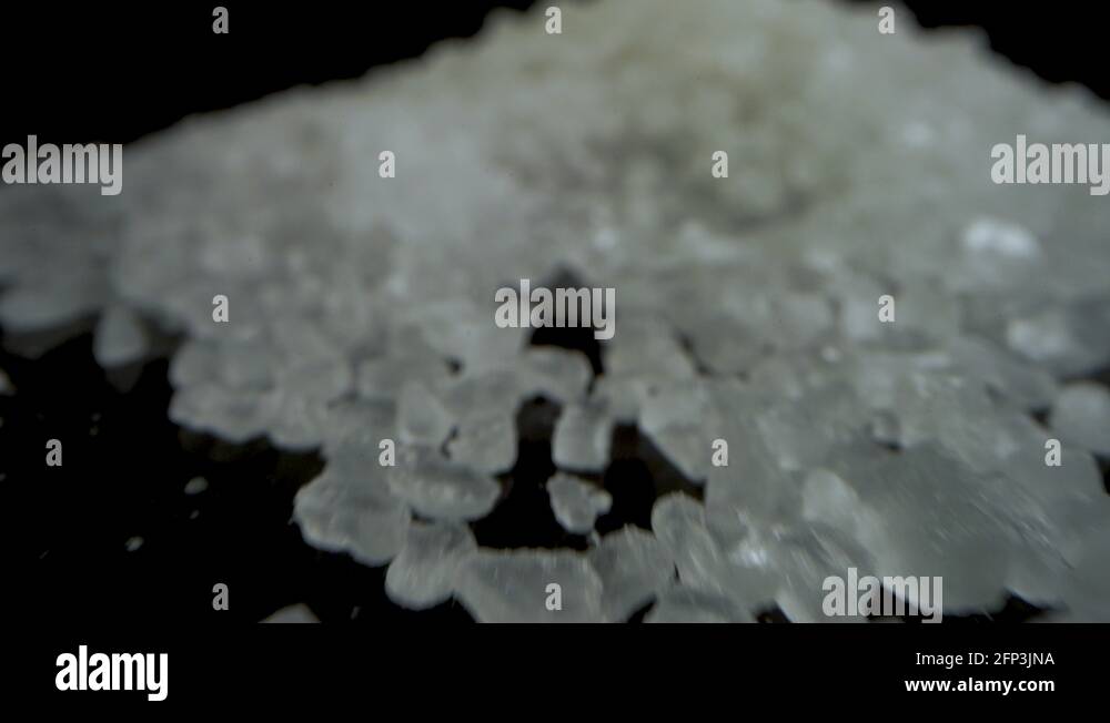 camera with a macro lensing forward and pushing crystals of sea salt ...