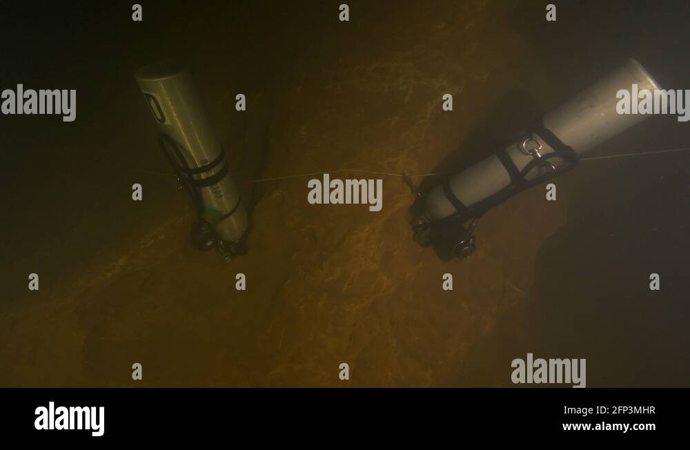 Tanks on the rock underwater, diver enters in the cave, Risorgenza ...