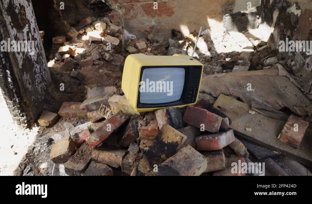 Old vintage TV on broken bricks in house destroyed by fire green screen ...