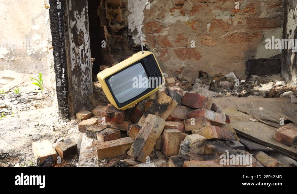 Small retro TV in house destroyed by fire flickering screen green ...