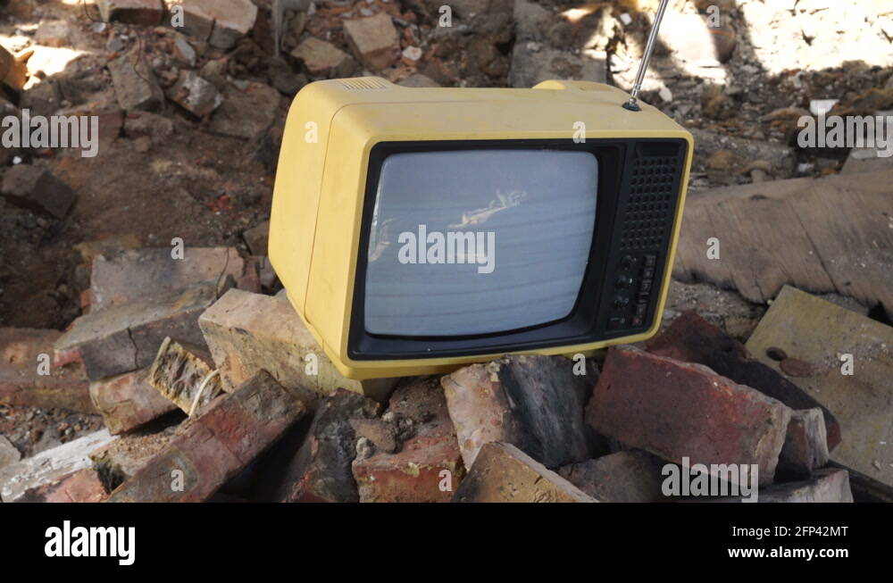 Small vintage TV on broken bricks in destroyed house glitch screen ...