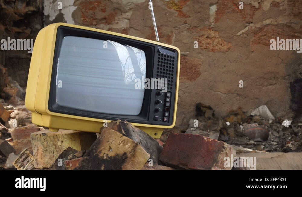 Vintage TV bad signal television screen green screen in destroyed house ...