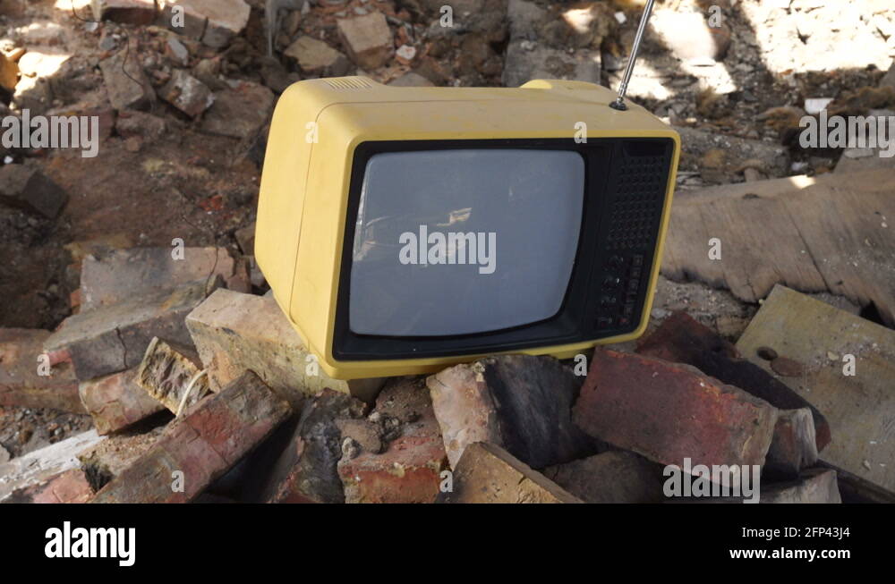 Turning on retro TV on broken bricks in destroyed house green screen ...