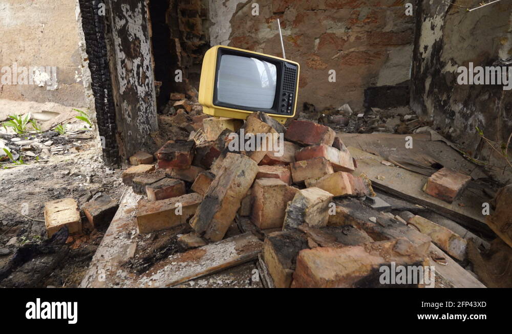 Old vintage TV on broken bricks in house destroyed by fire green screen ...