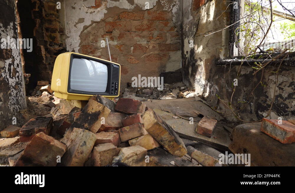 Small vintage TV on broken bricks in destroyed house glitch screen ...