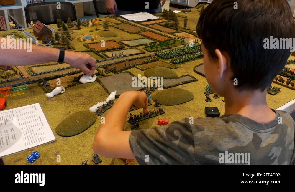 Adults teach young people how to play tactical civil war gaming Stock ...