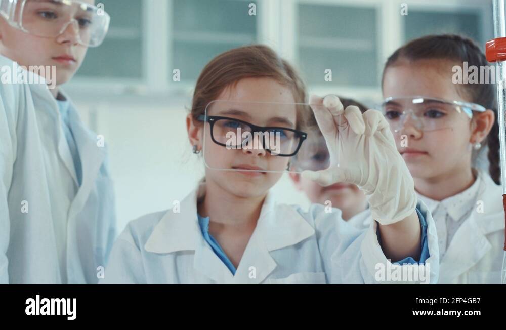 Clever futuristic children scientists studying in a laboratory ...
