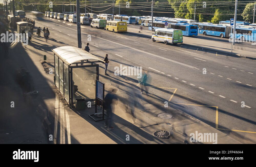 passengers waiting and boarding buses at the bus terminal, time lapse ...
