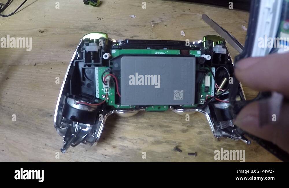 Fixing a circuit board inside of a video game controller Stock Video ...