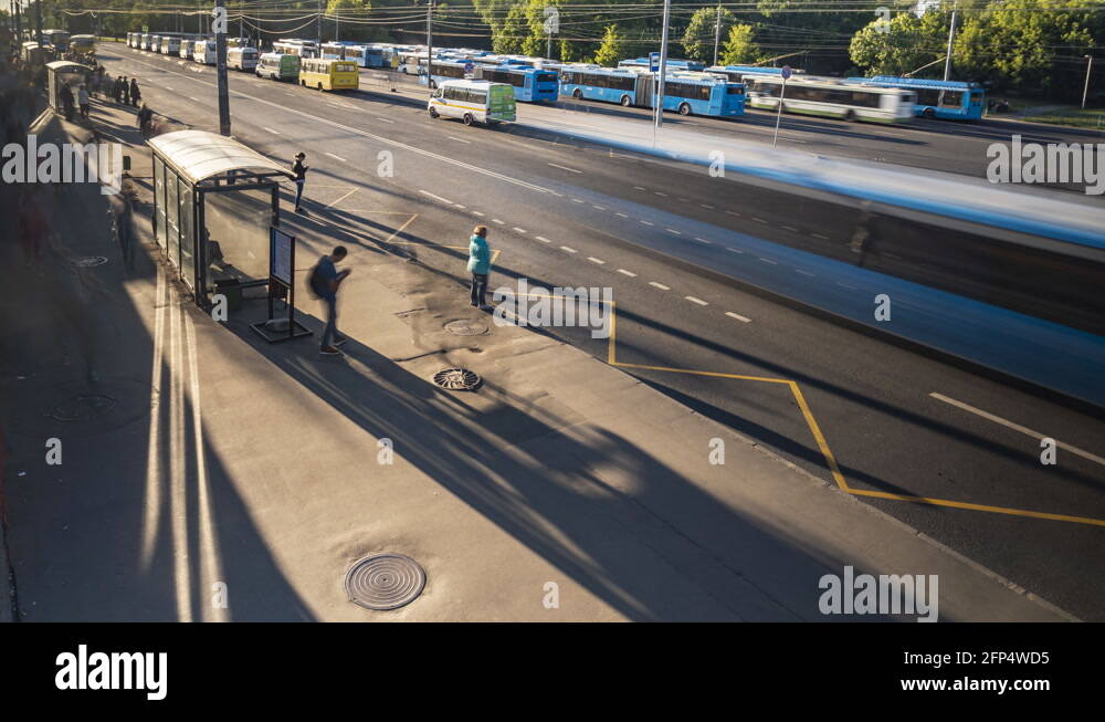 passengers waiting and boarding buses at the bus terminal, time lapse ...