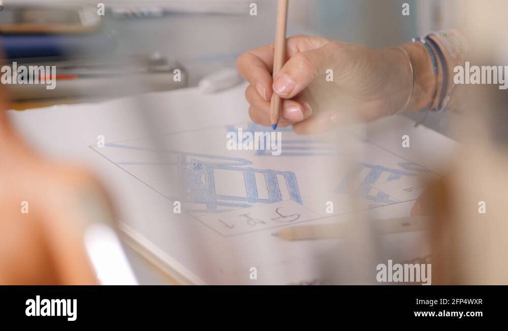 Artist female hands use pencil as a ruler to draw a line on paper Stock ...