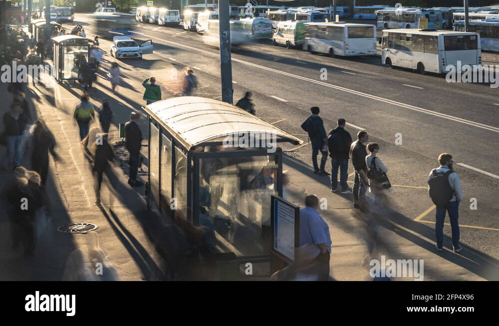 passengers waiting and boarding buses at the bus terminal, time lapse ...