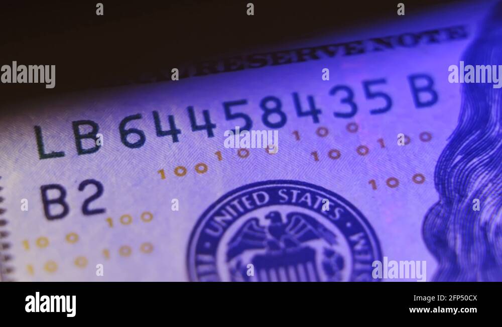 Close up of a one hundred-dollar bill under UV light, blacklight Stock ...