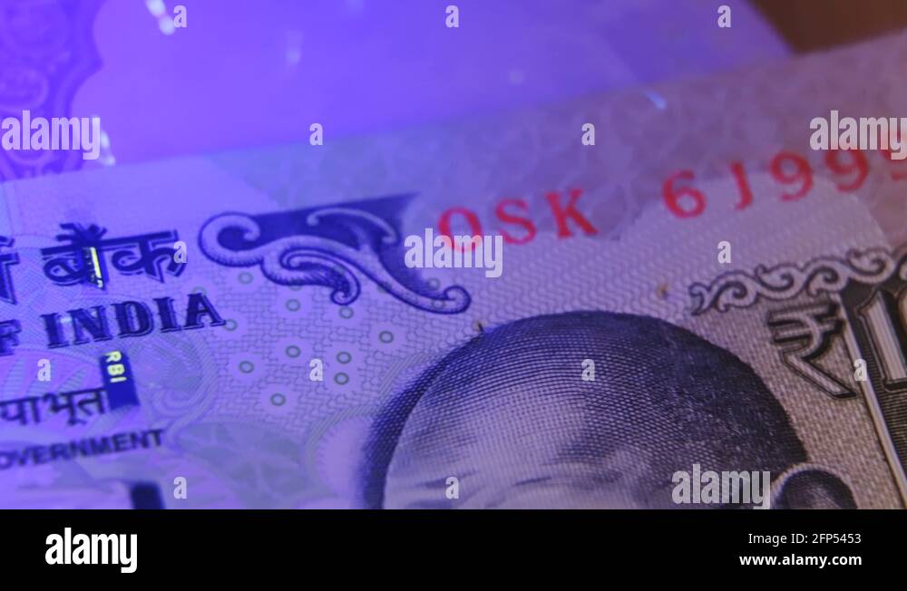 Indian rupee under UV light, counterfeit check, blacklight Stock Video ...