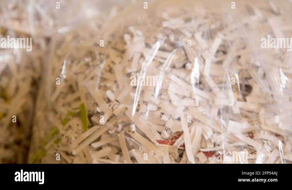 Close up pan over a bag of shredded paper waiting to be recycled Stock ...