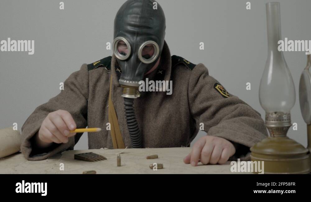 Army man at emergency operations center wearing gas mask at the map ...